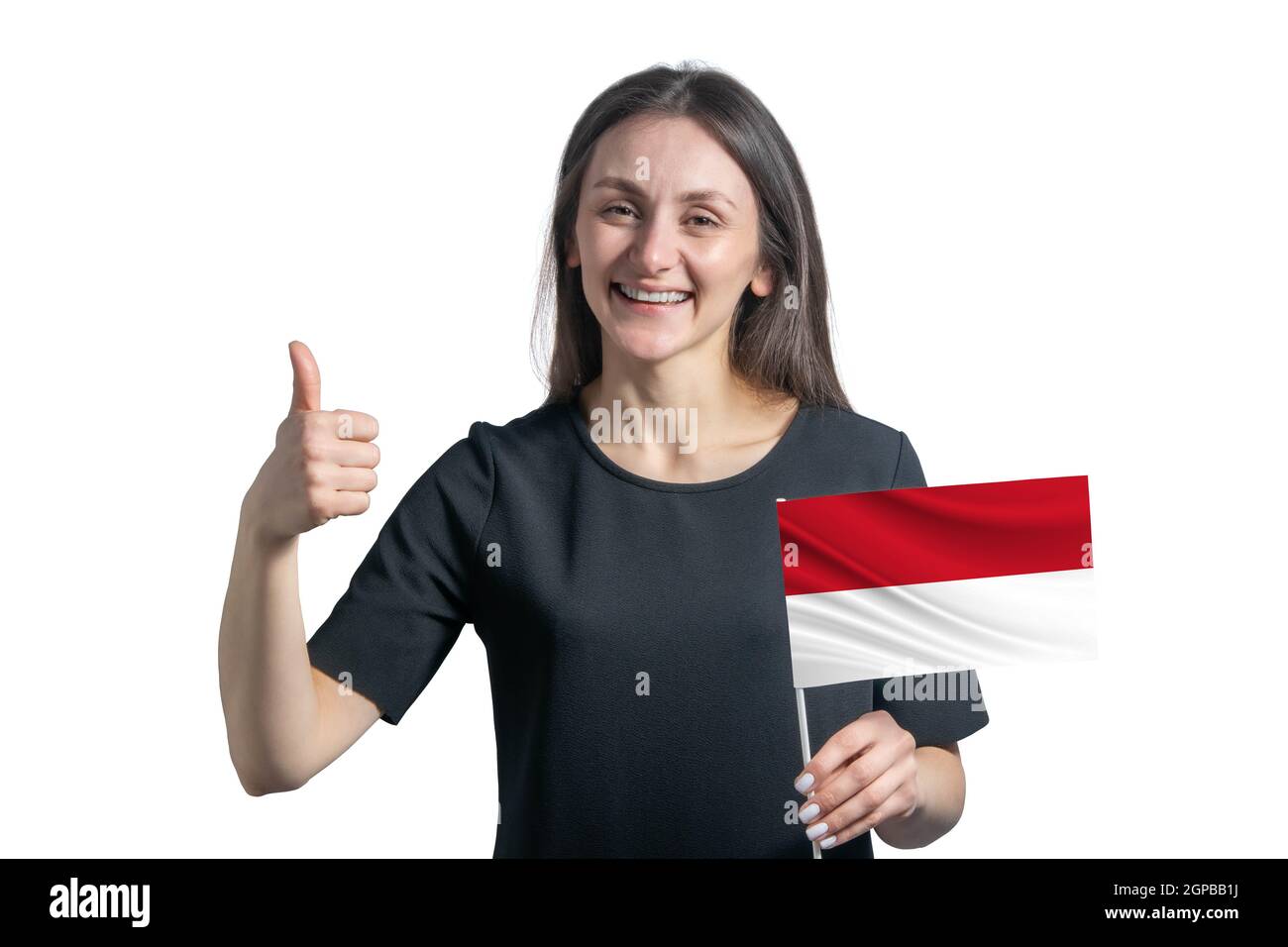 Happy young white woman holding flag of Monaco and shows the class by ...