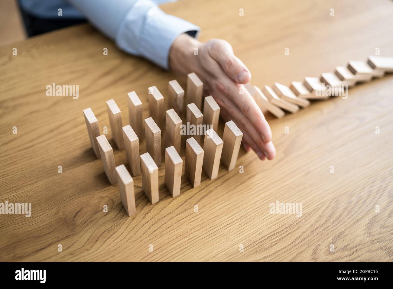 Domino Fall Prevention And Stop Using Hand Stock Photo - Alamy