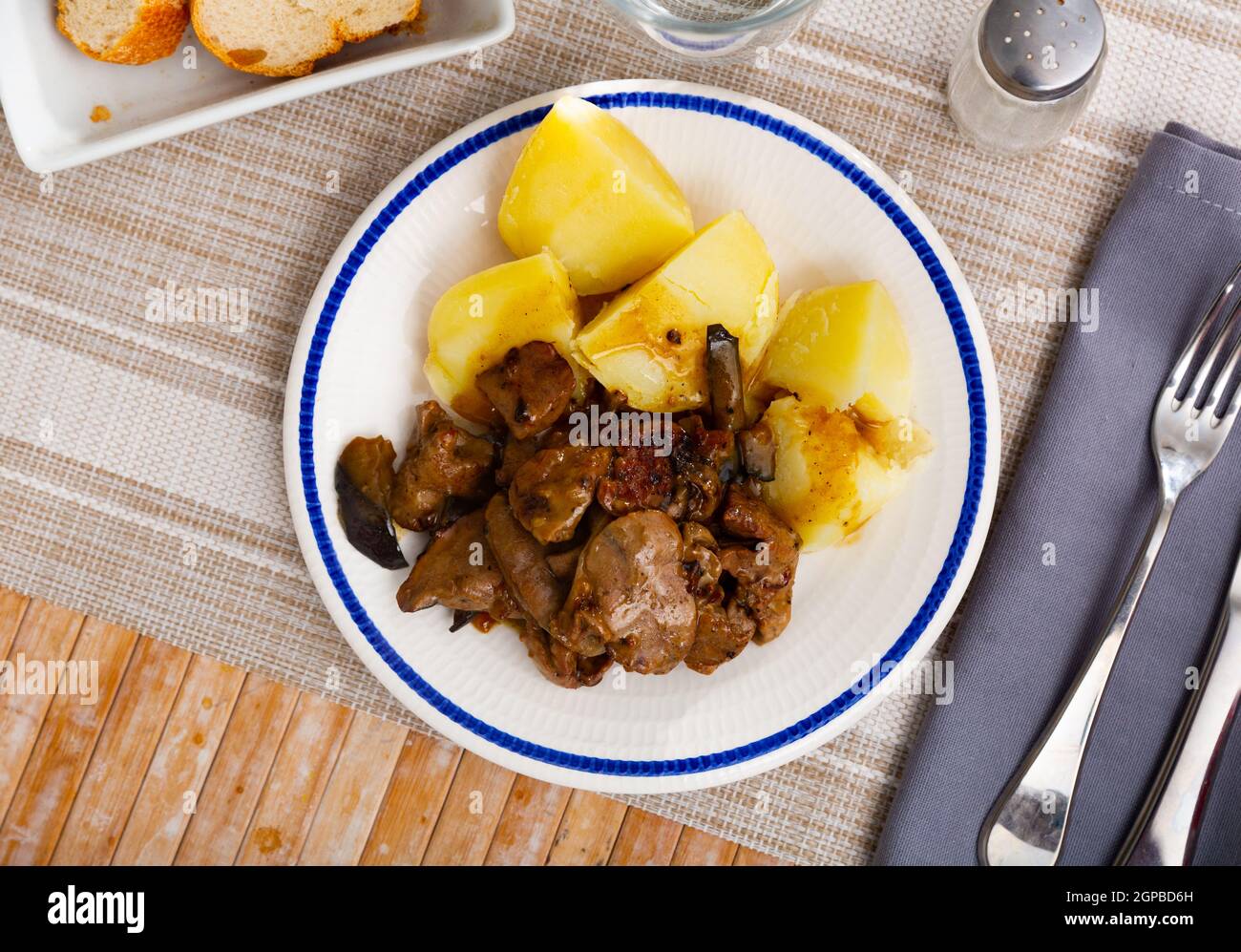Fried rabbit liver served with boiled potato Stock Photo - Alamy