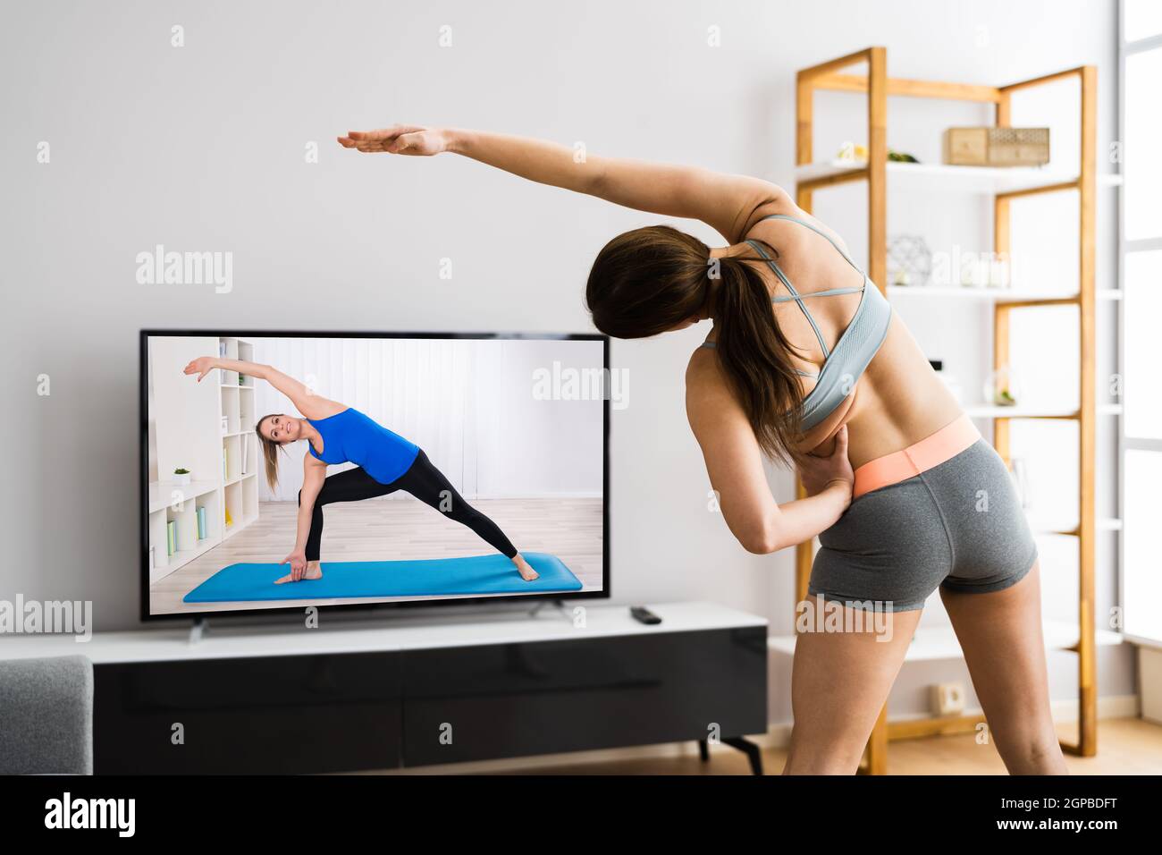 TV Online Fitness Exercise Workout For Woman Stock Photo - Alamy