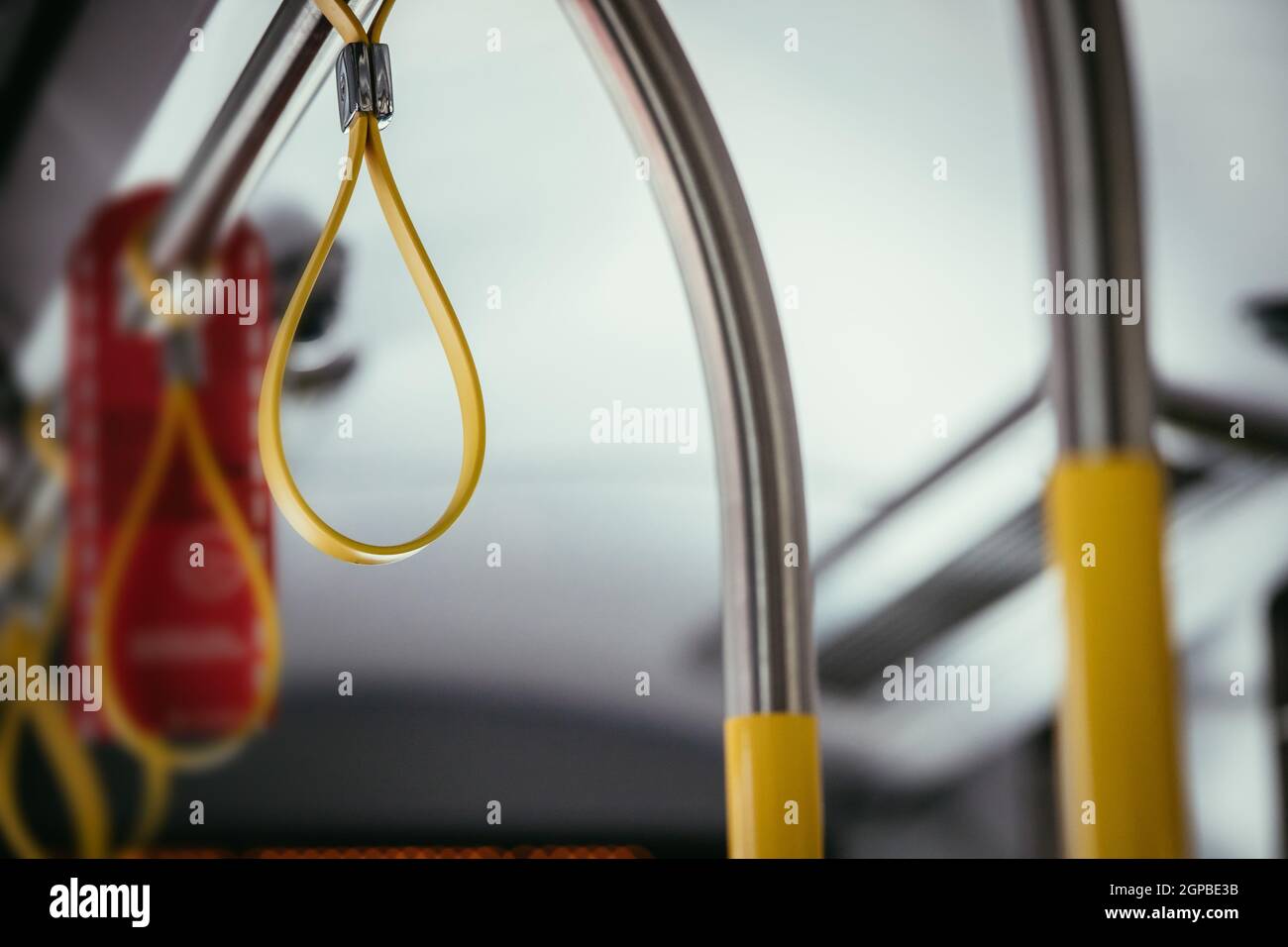 Hold on straps in a bus, commuting, public transport Stock Photo - Alamy