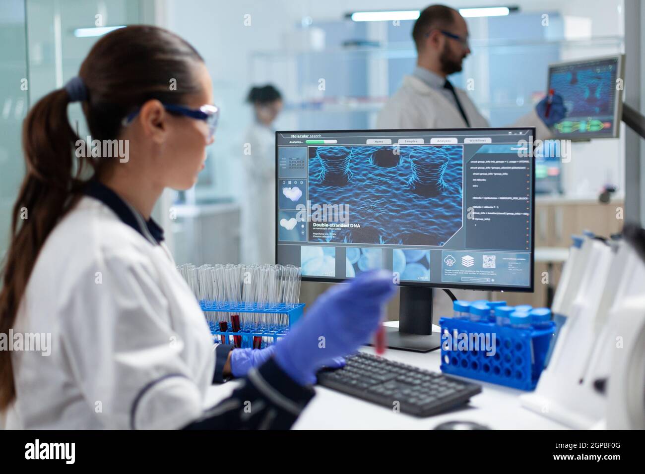 Specialist biologist researcher holding blood medical test tubes ...