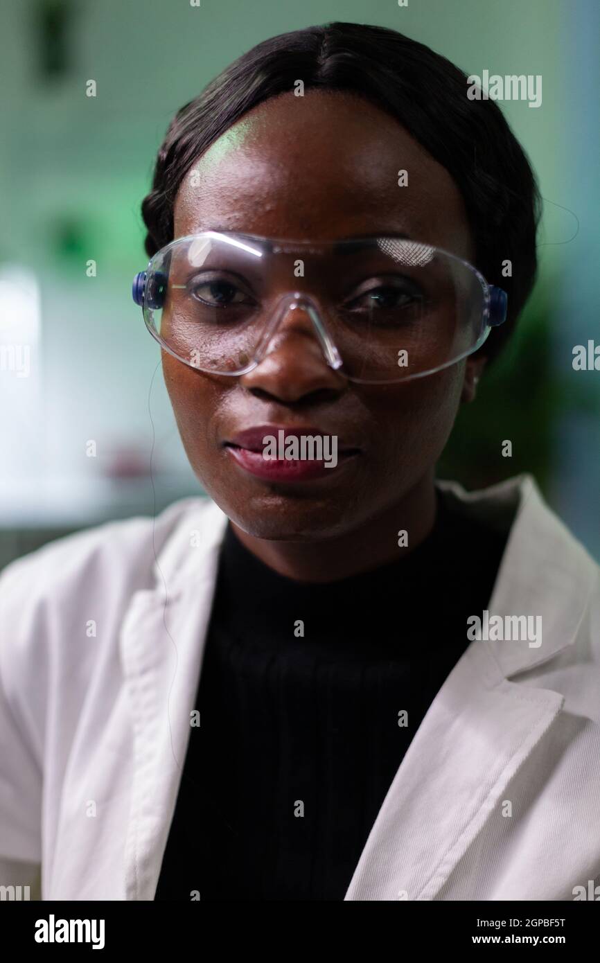 Portrait of african american biologist doctor looking into camera ...