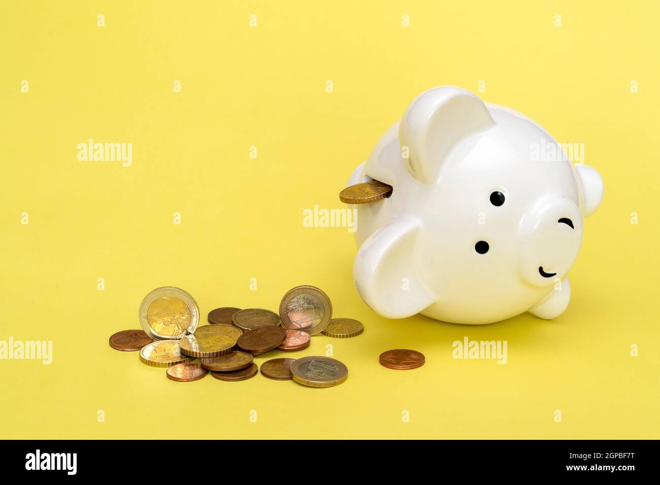 Money spilling out of the piggy bank on the yellow background Stock ...