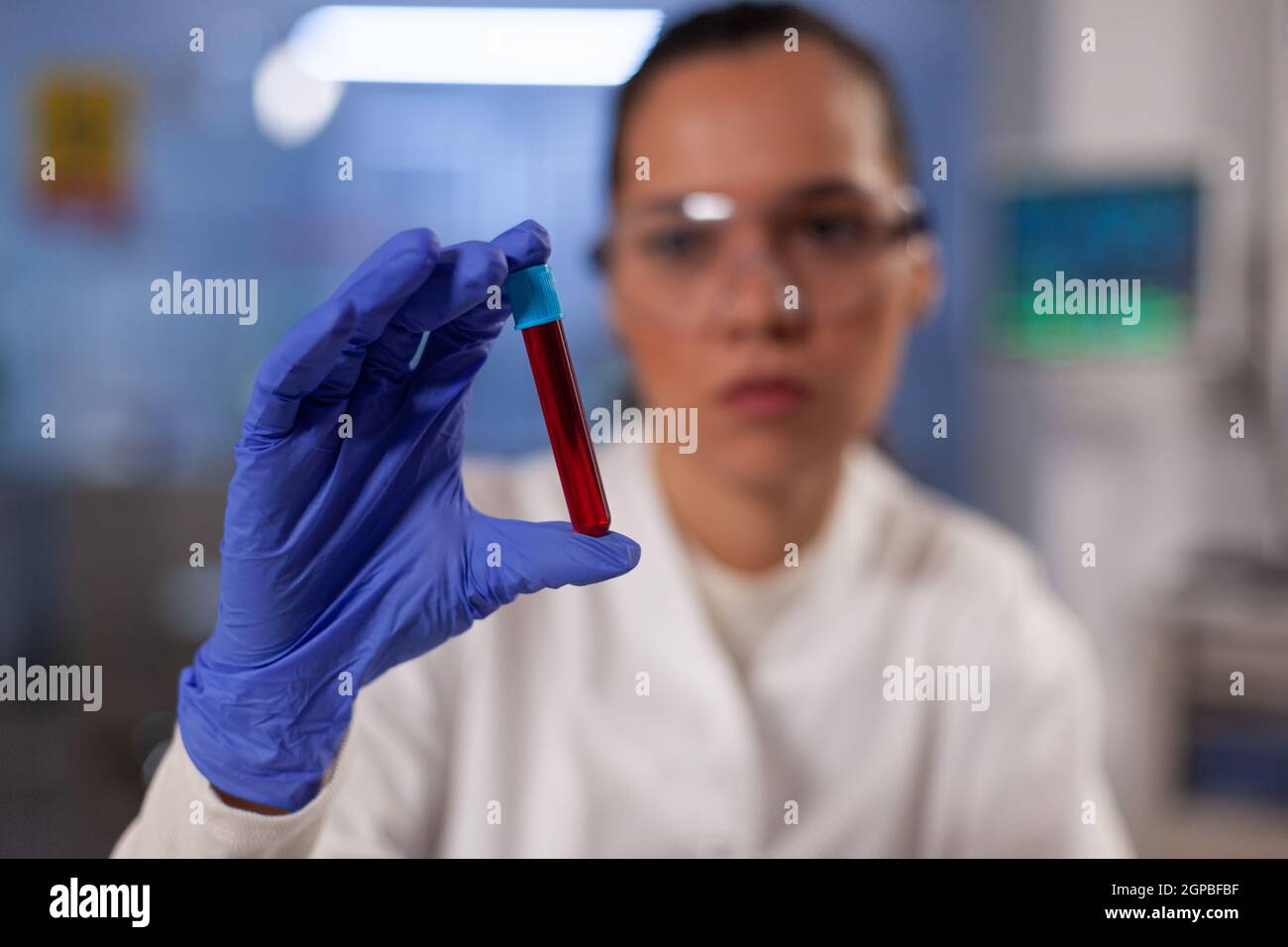 Scientific research doctor holding test tube with blood for modern ...