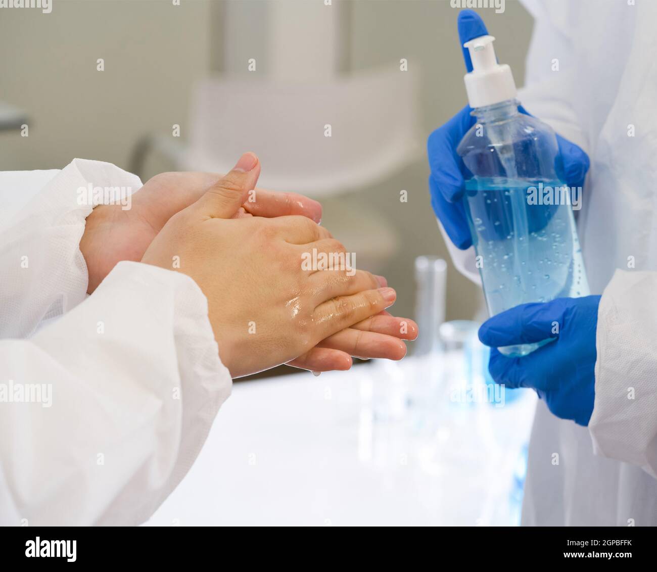 Epidemiological researchers in virus protective clothing washing hands ...