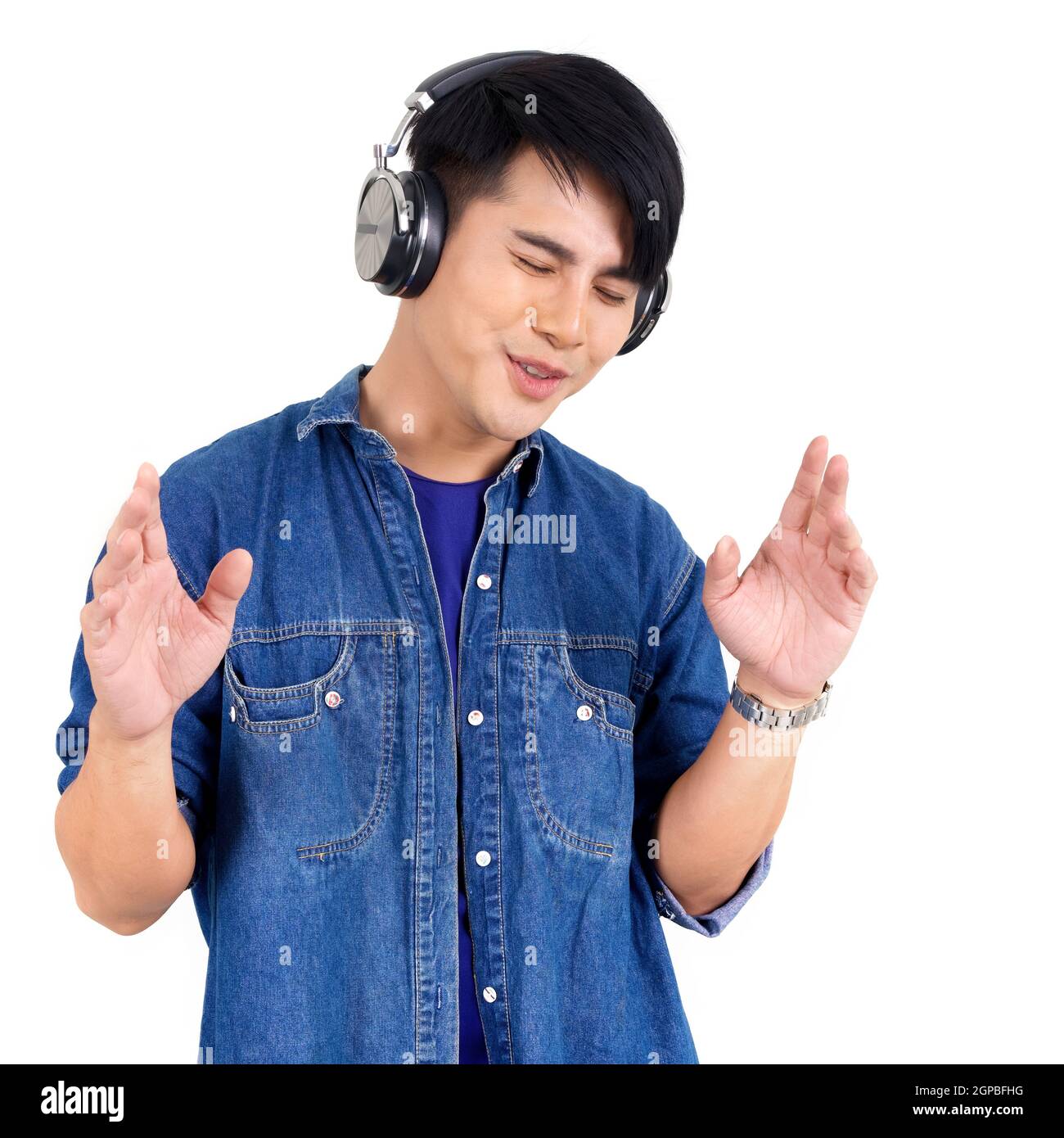 Young asian man dance, swaying, and lifting his arms rhythmically while ...