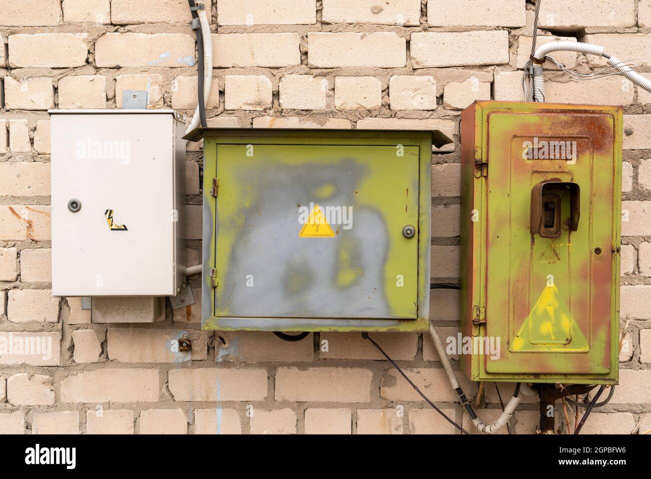 Set of connected electric boxes on the brick wall Stock Photo - Alamy
