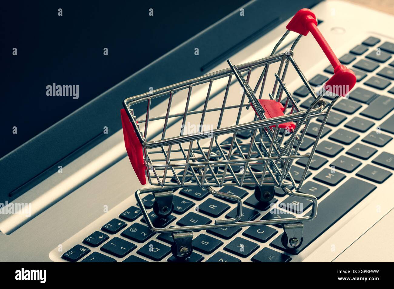 E-commerce. Shopping cart on laptop keyboard. Conceptual image Stock ...