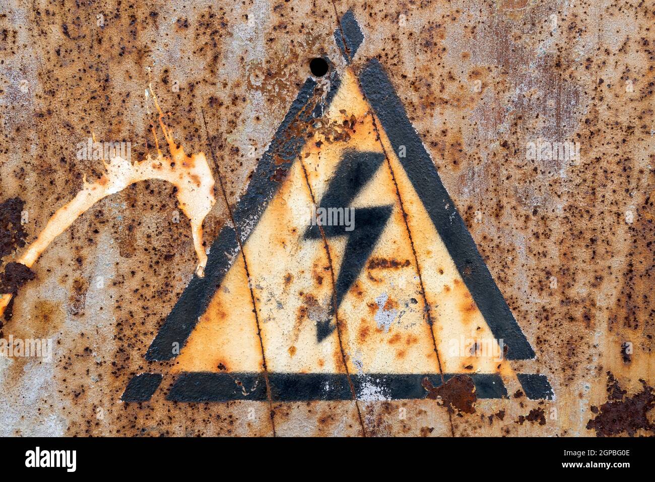 Old, rusty high voltage warning sign Stock Photo - Alamy