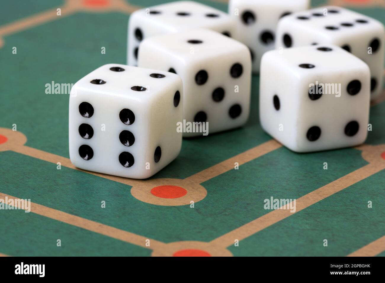 Several white dices on board game background Stock Photo - Alamy