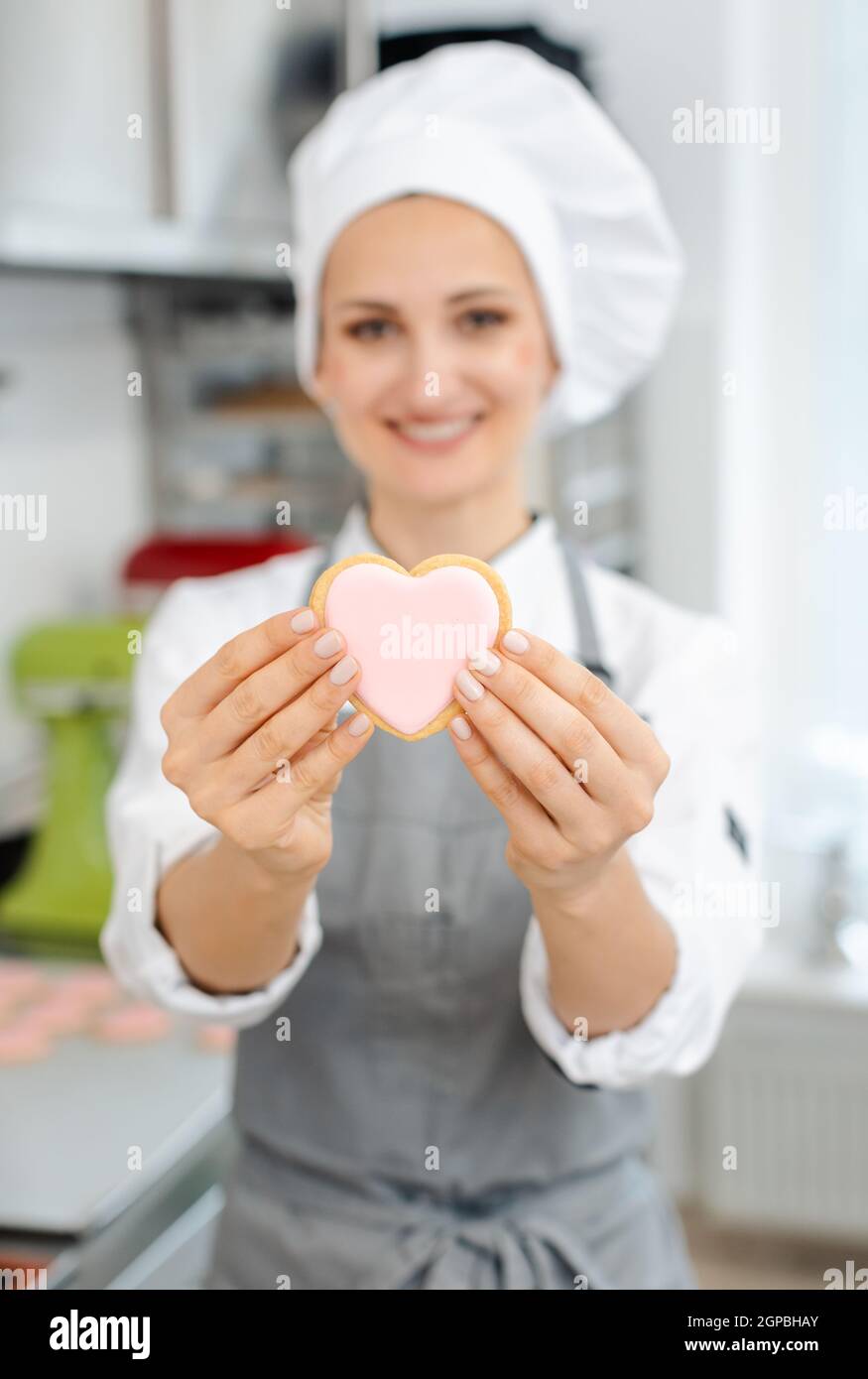 Pastry chef is in love with her trade showing it with heart shaped ...