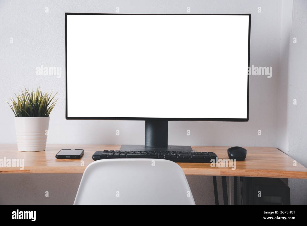 Computer monitor with white blank screen on the business desk with ...