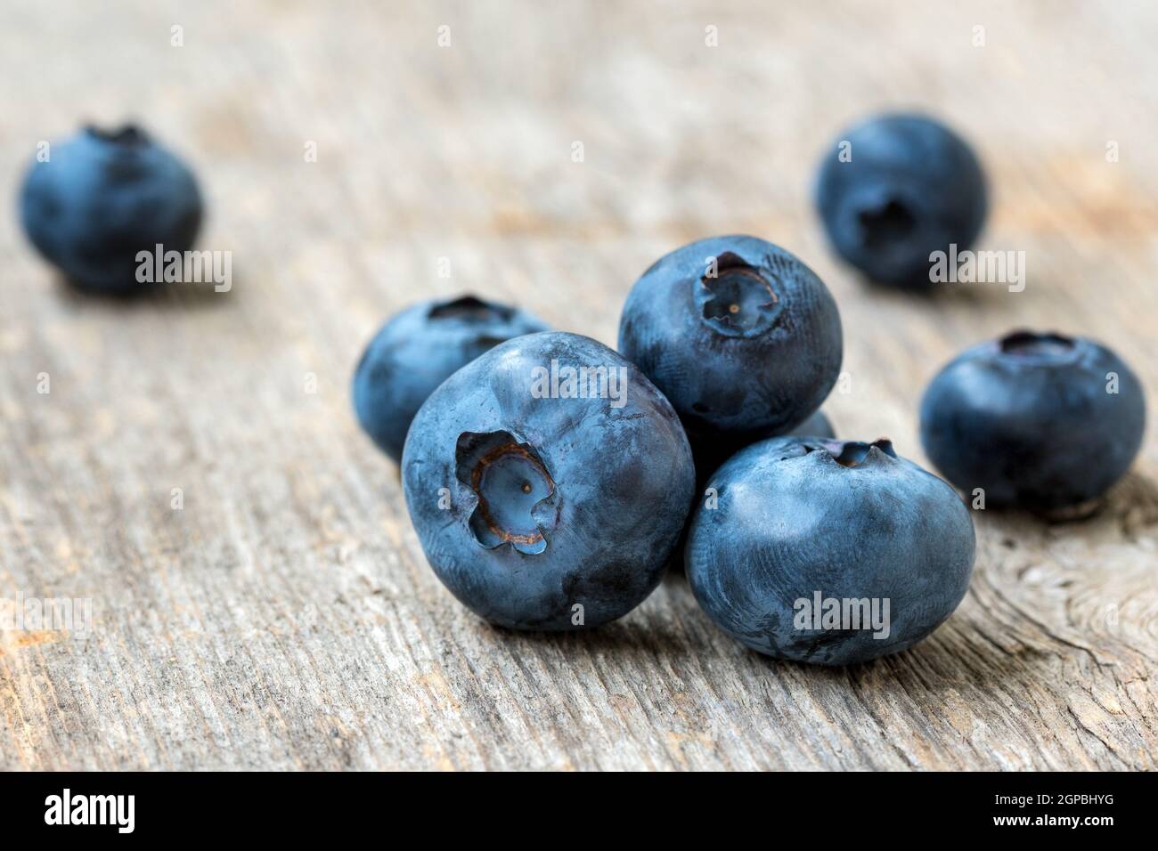 Blue heathberry (Vaccinium myrtillus) on rustic wood table background ...