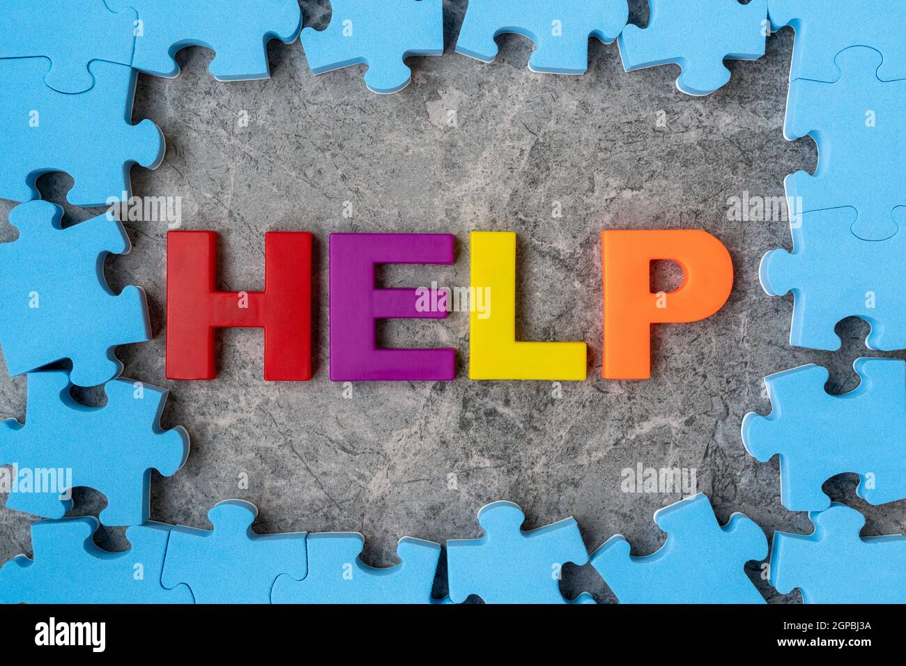 Word HELP in a middle of jigsaw puzzle frame.Business concept, help ...