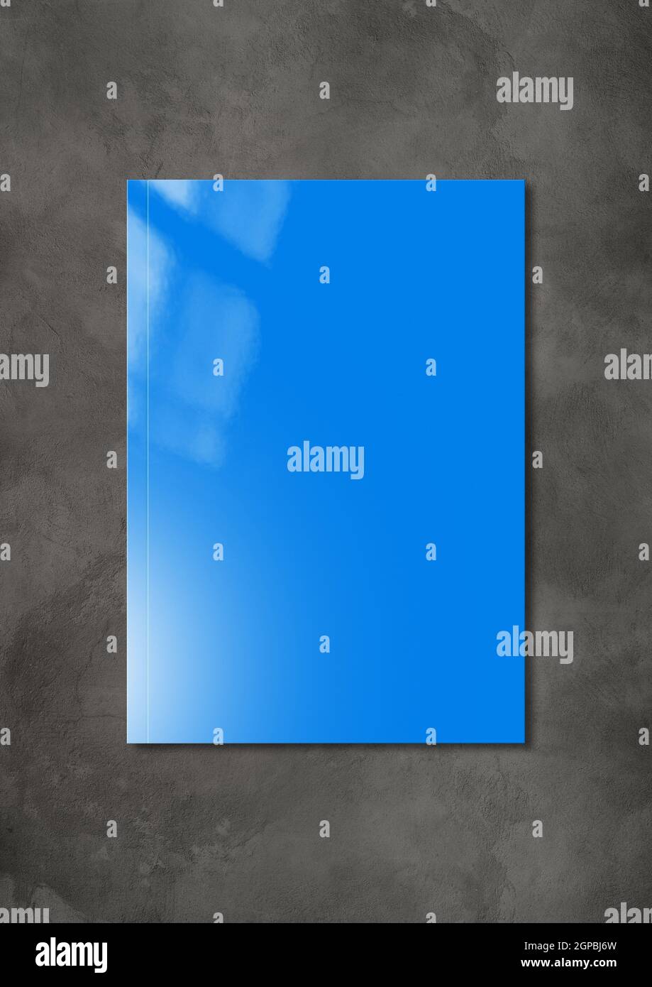 Blue booklet cover isolated on dark concrete background, mockup ...