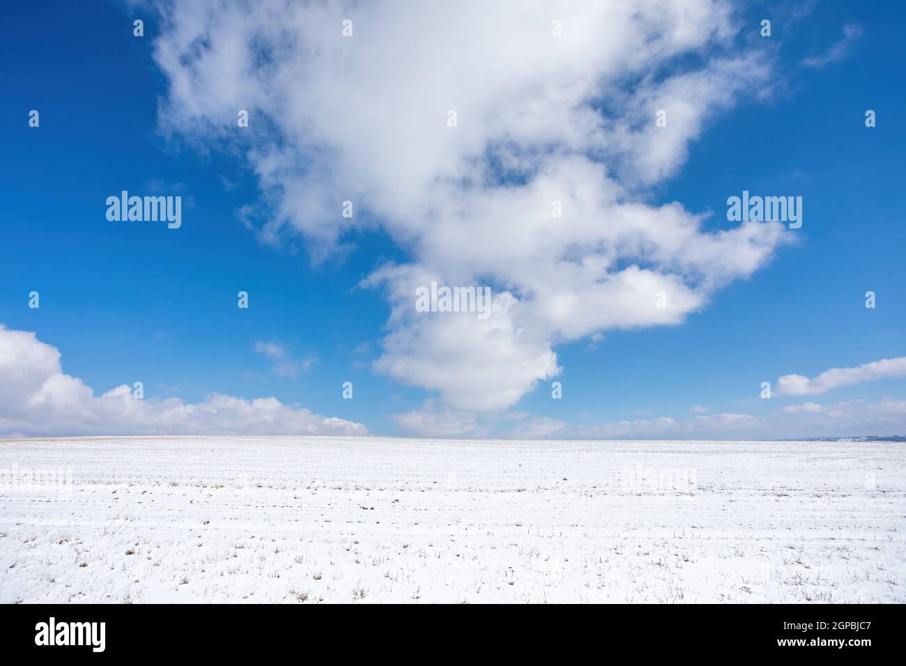Simple winter background with beautiful lines from skier and big clouds ...