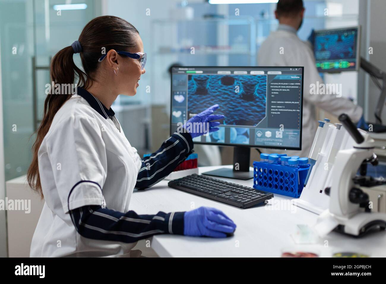 Scientist biologist researcher woman looking at coronavirus expertise ...