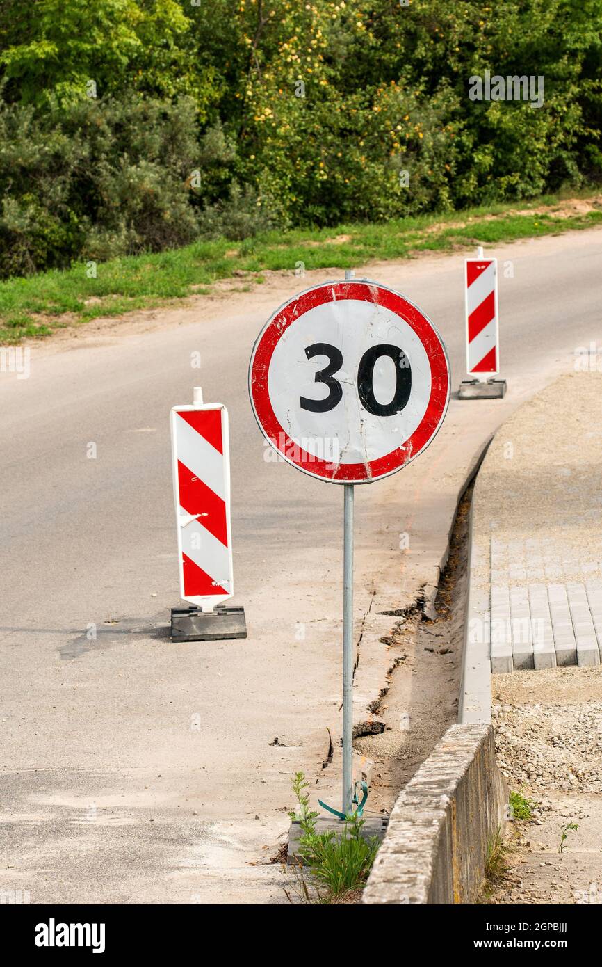 Warning of the road works which are ahead. The speed limit sign with ...