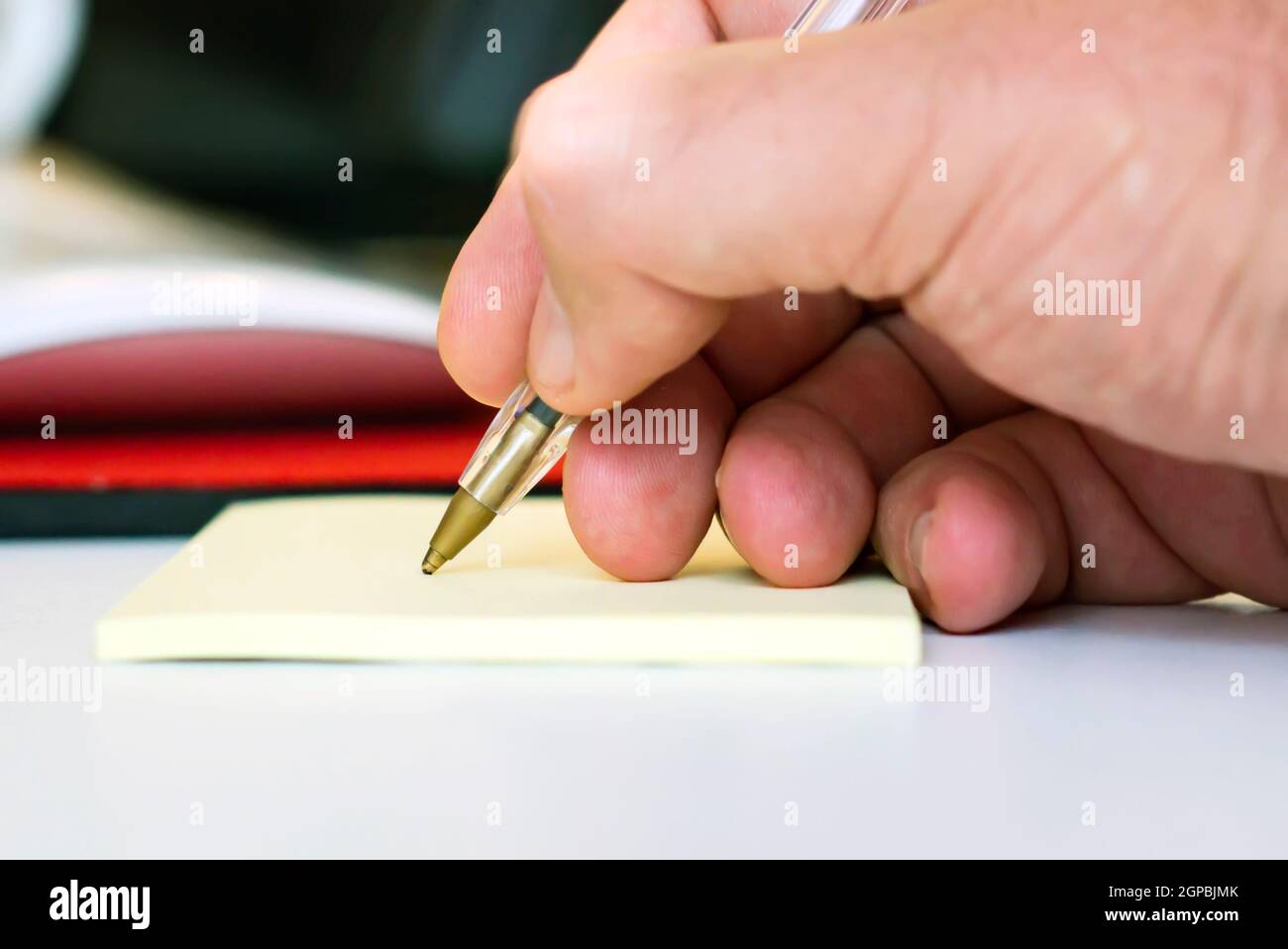 Man writing with a ballpoint pen. Handwriting Stock Photo - Alamy
