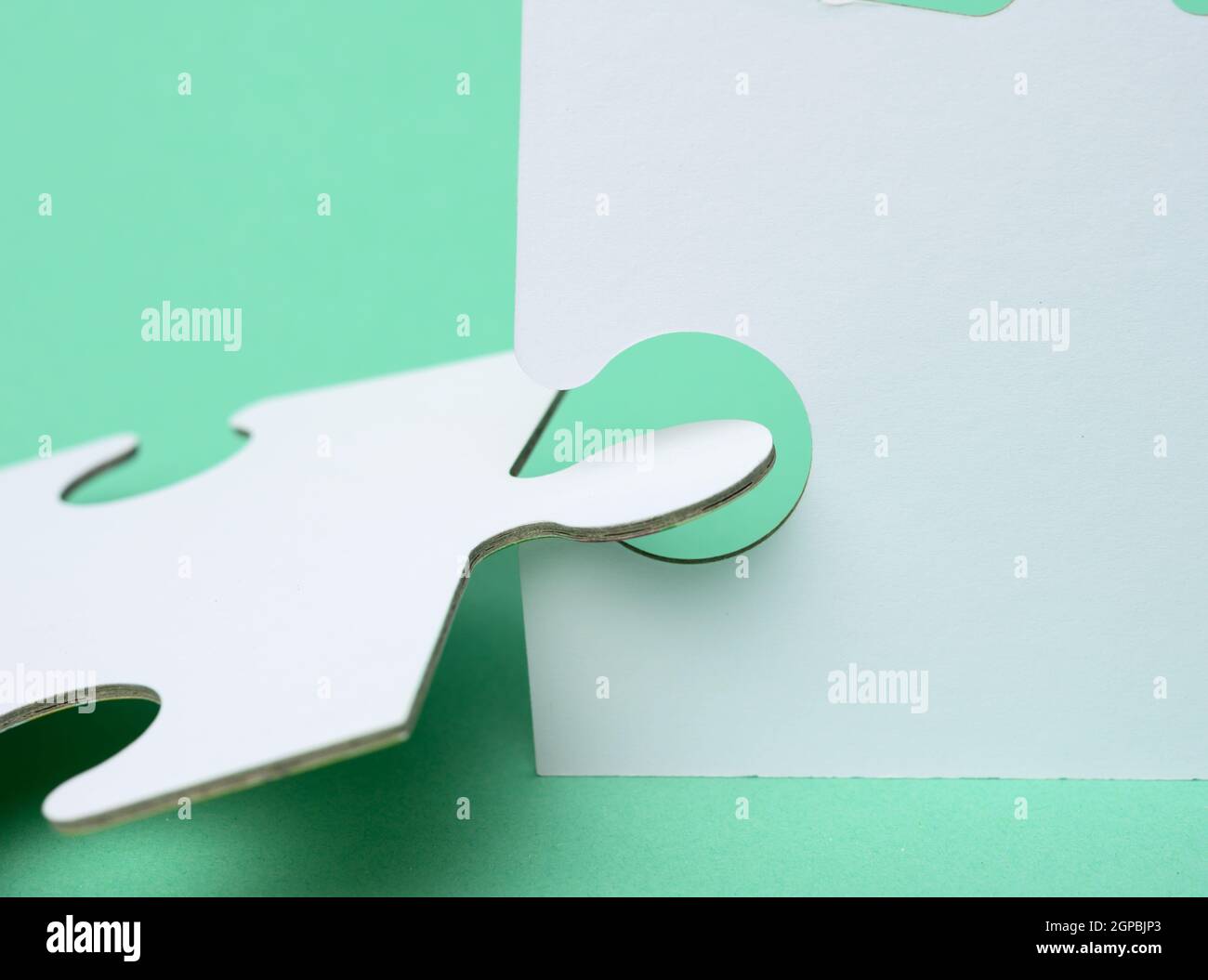 white paper puzzles on a green background, connection, close up Stock ...
