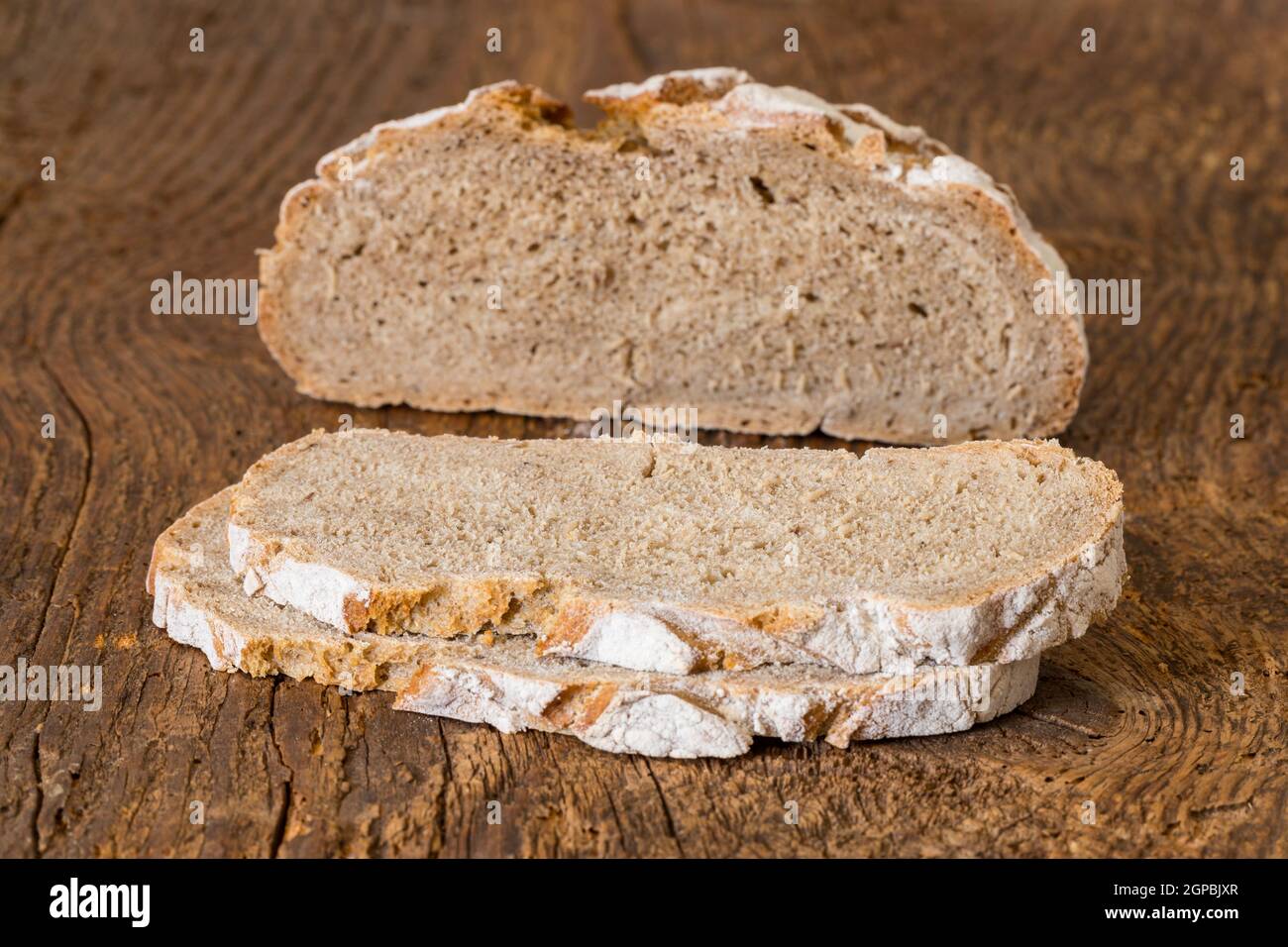 cut rye bread on dark wood Stock Photo - Alamy