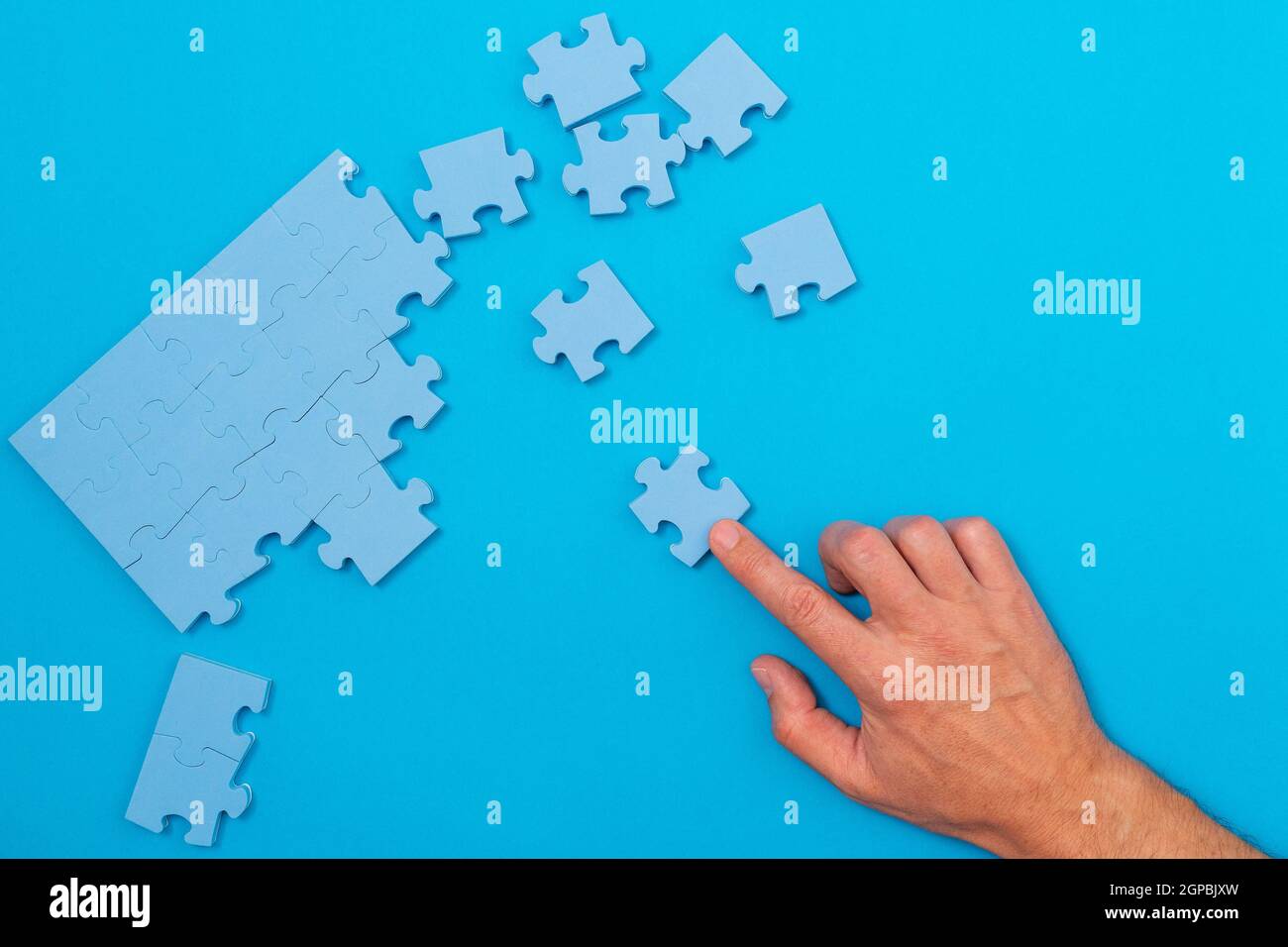 Concept of business. Hand pointing at pieces of puzzles and collecting ...