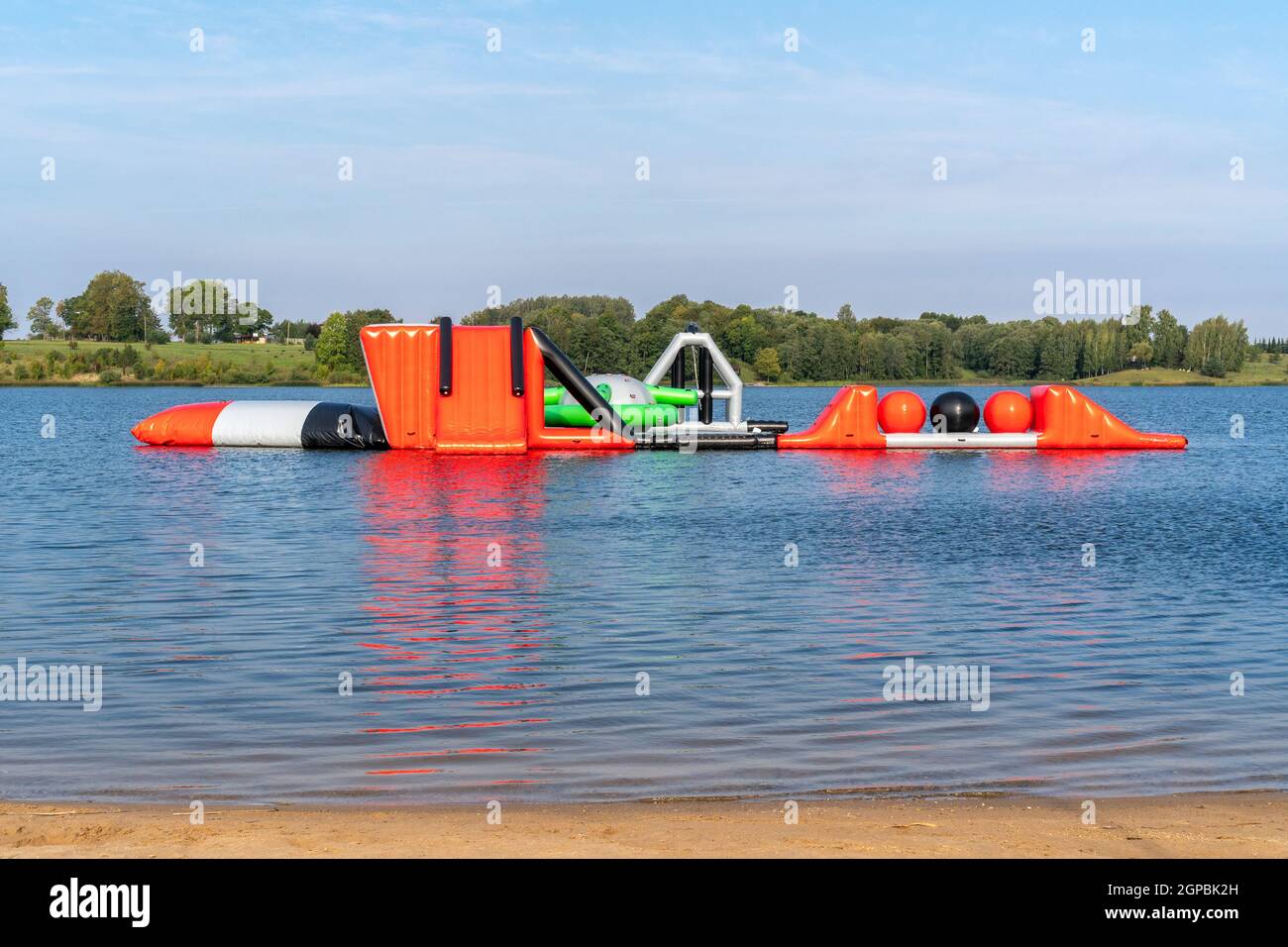 Bouncy castle on the lake. Inflatable playground for children in the ...