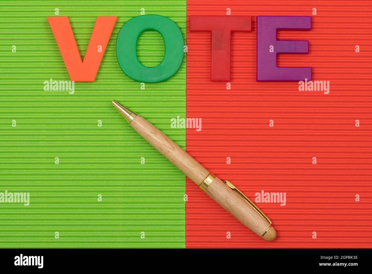 The word Vote with with a pen lying on the contrast background Stock ...