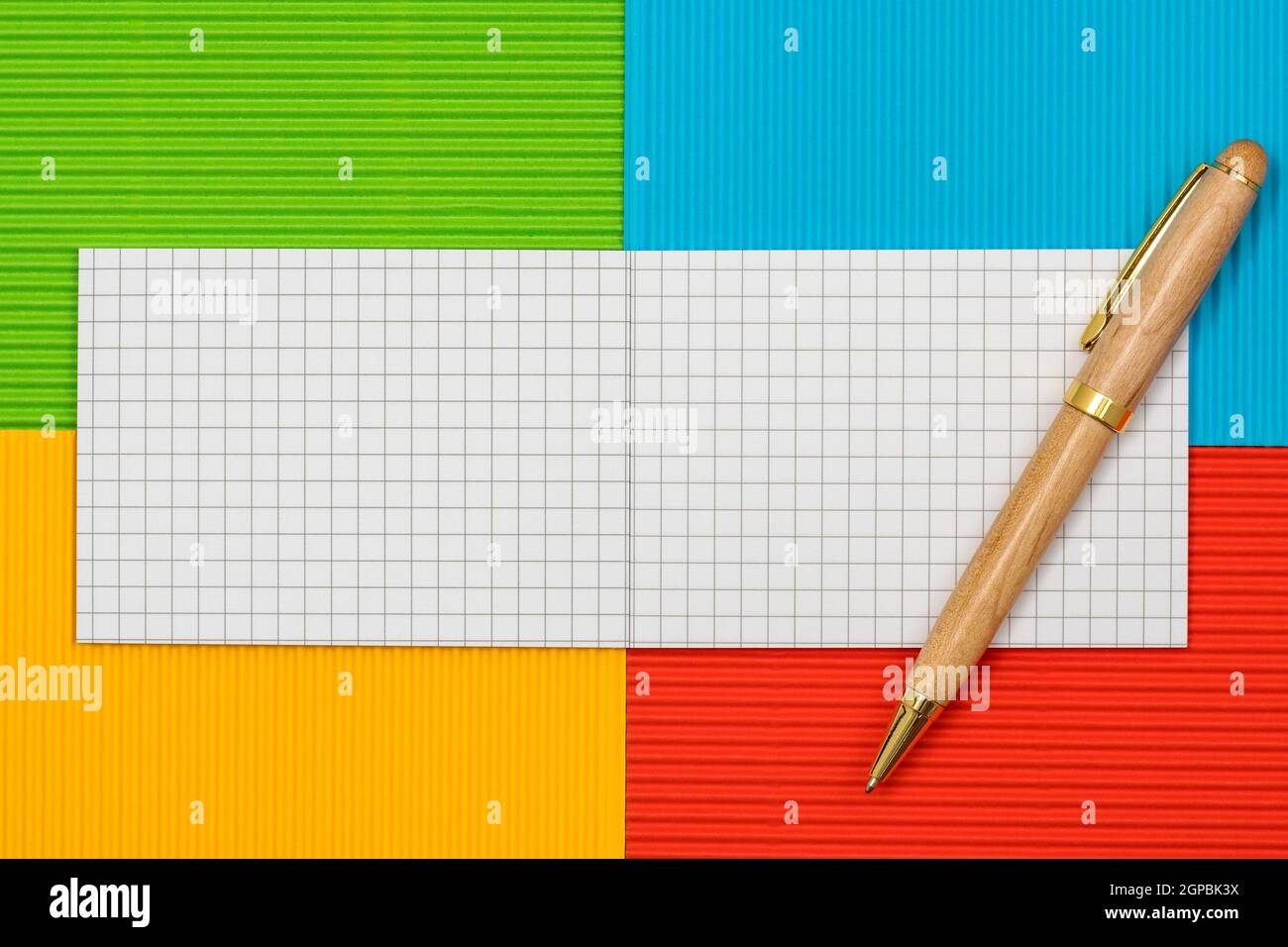 Small notebook with a pen on the color paper background Stock Photo - Alamy