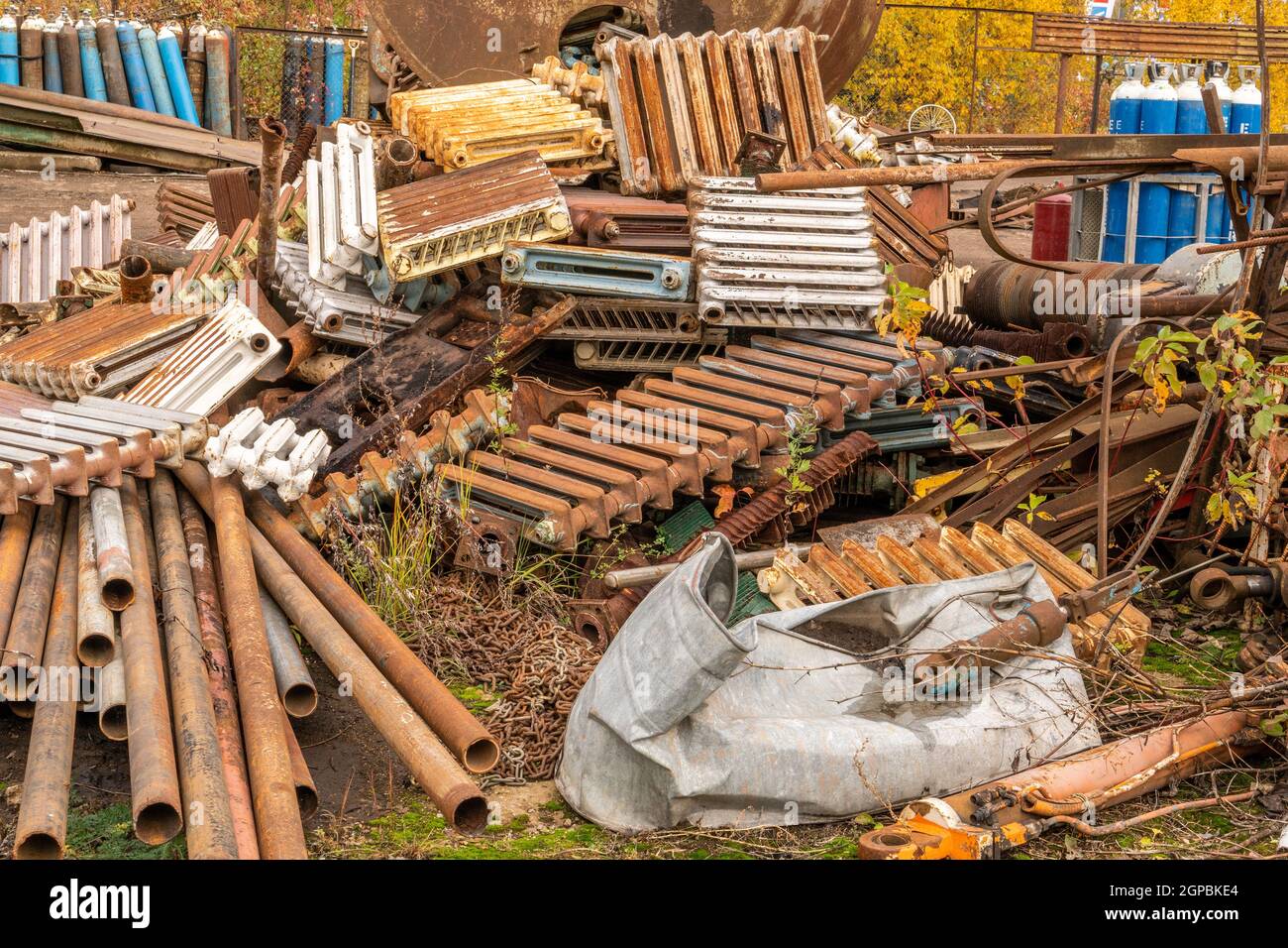 Scrap metal waste is stored in a recycling yard waiting to be melted ...