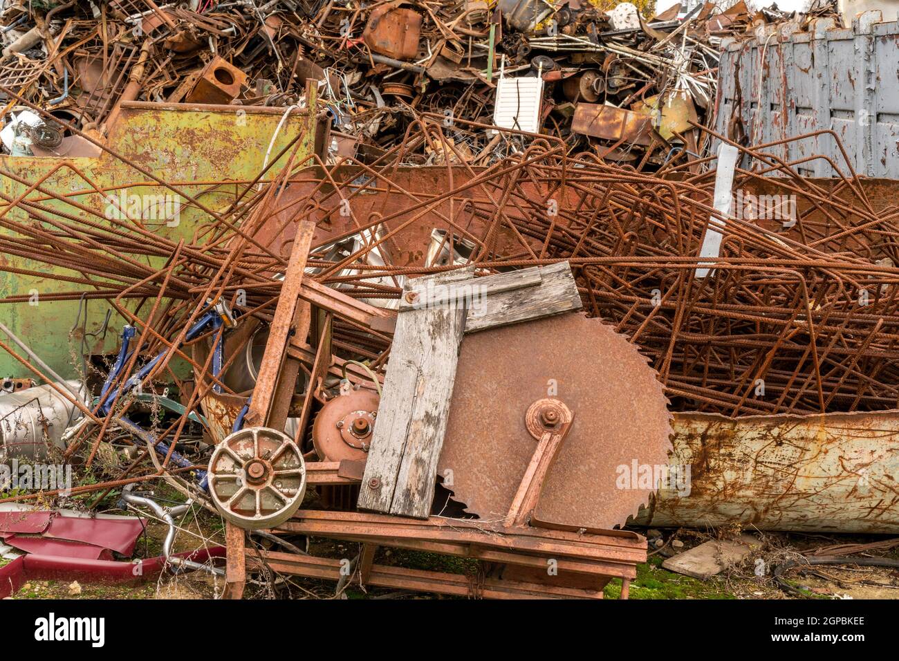 Scrap metal waste is stored in a recycling yard waiting to be melted ...