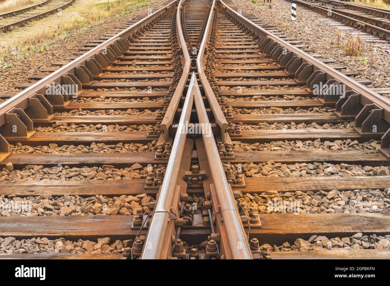Two railway tracks merge together. Old railway junction with several tracks Stock Photo - Alamy