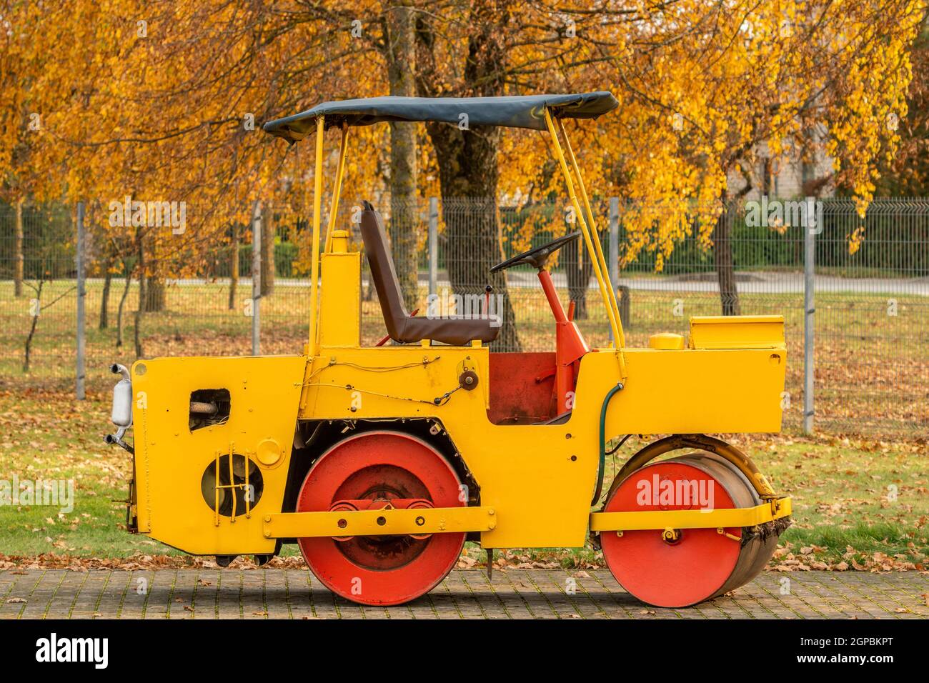 Side view small yellow asphalt compactor. Vibration roller compactor ...