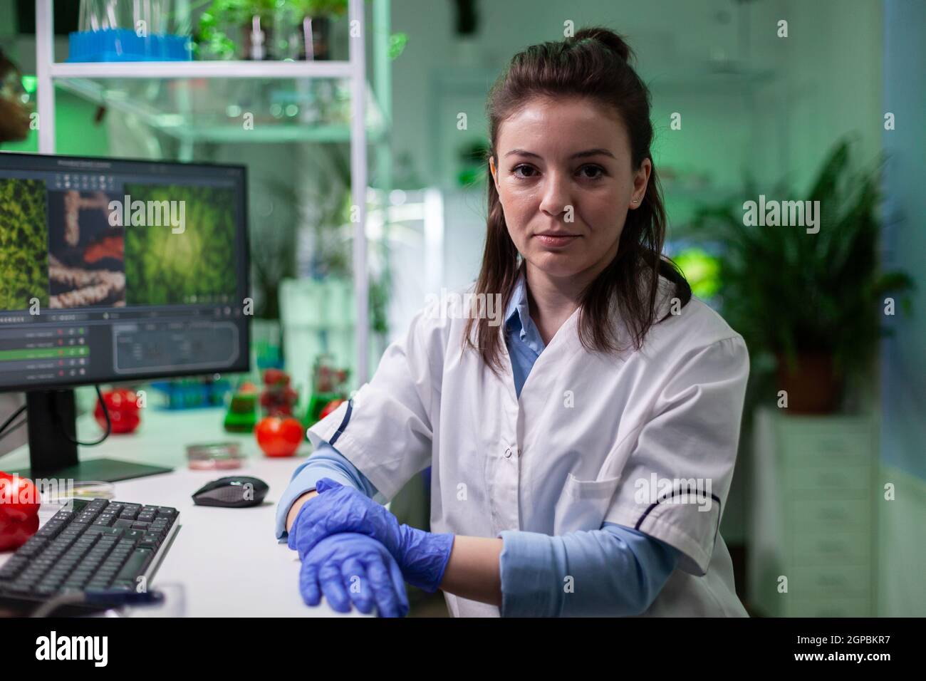 Portrait of biologist woman in white coat working in pharmaceutical ...