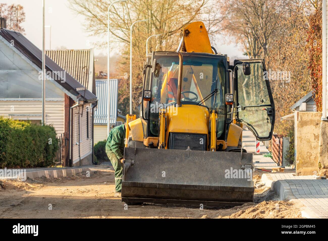 Mechanic fixing something on the tractor. Broken machinery on the road ...