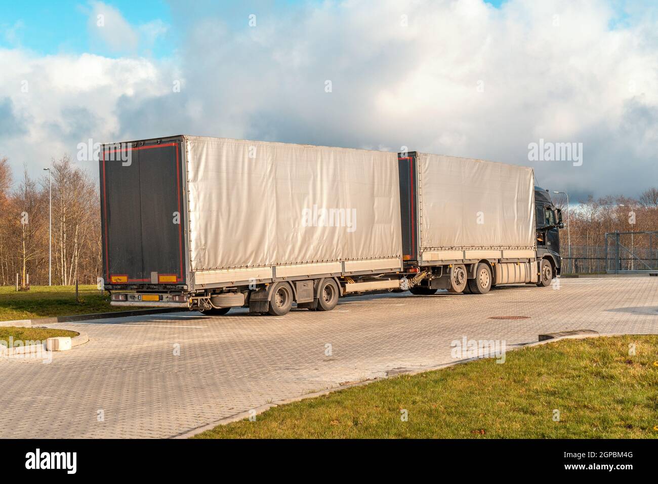Truck with goods delivery waiting in front of the gate Stock Photo - Alamy