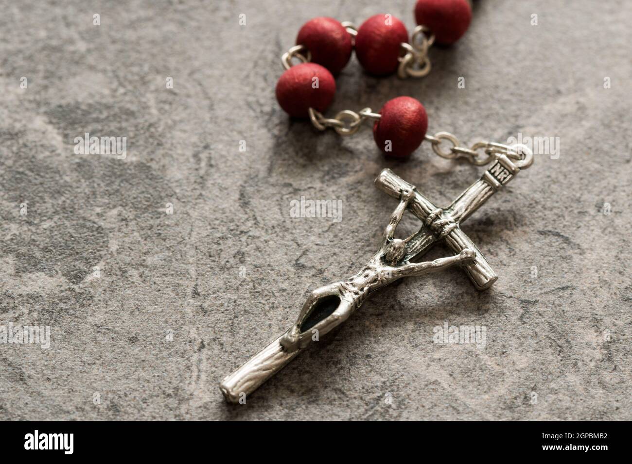 Catholic rosary on the stone background. Close-up view. Religion ...