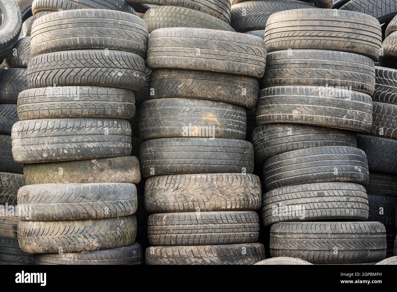 Used car tires pile in the tire repair shop yard Stock Photo - Alamy