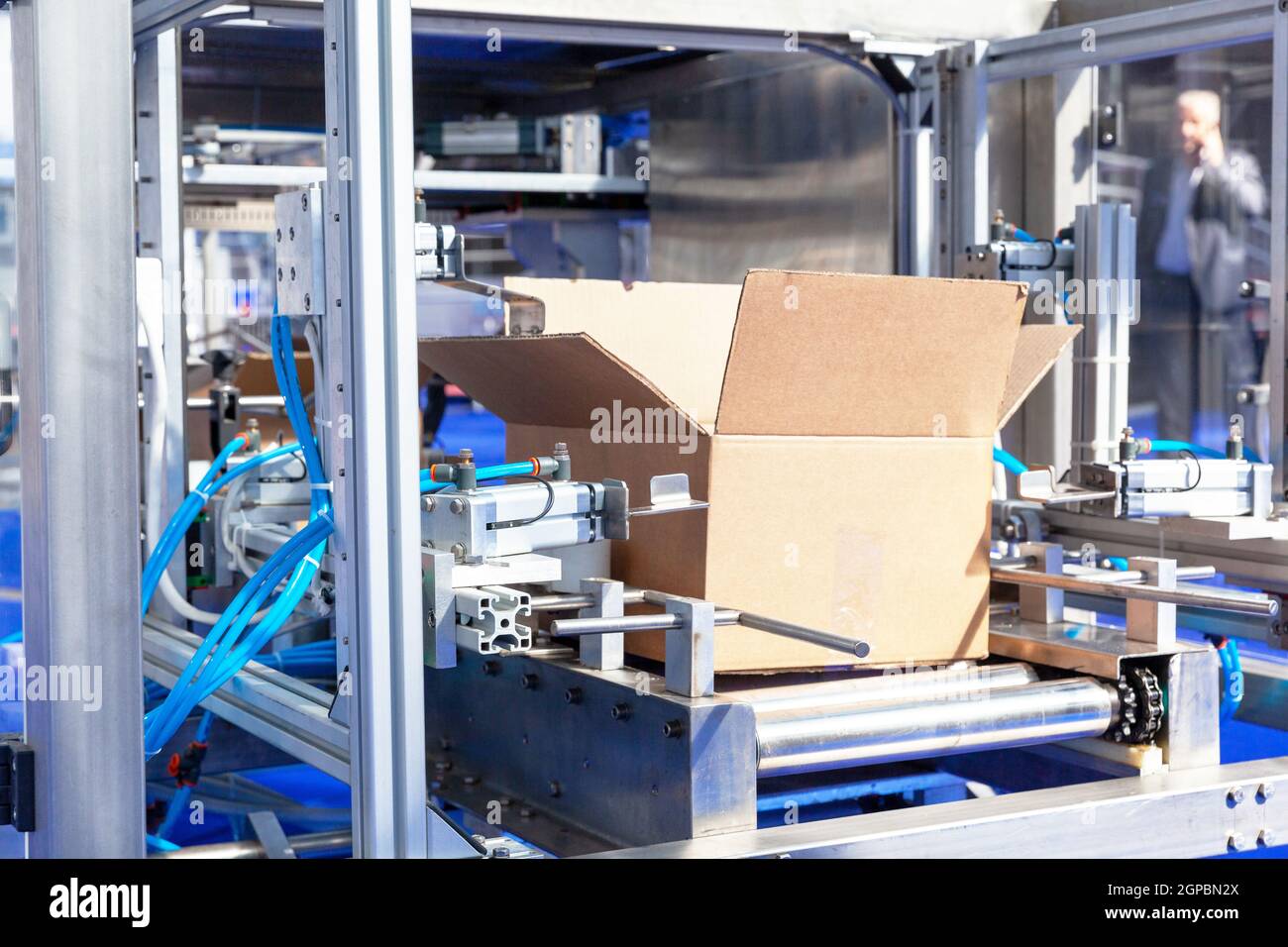 Cardboard package box packing machine Stock Photo - Alamy