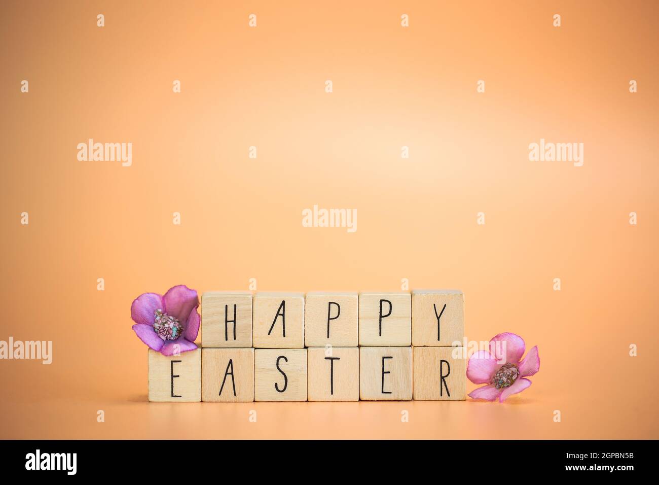 Happy Easter Holiday text on bright orange pastel colored background ...