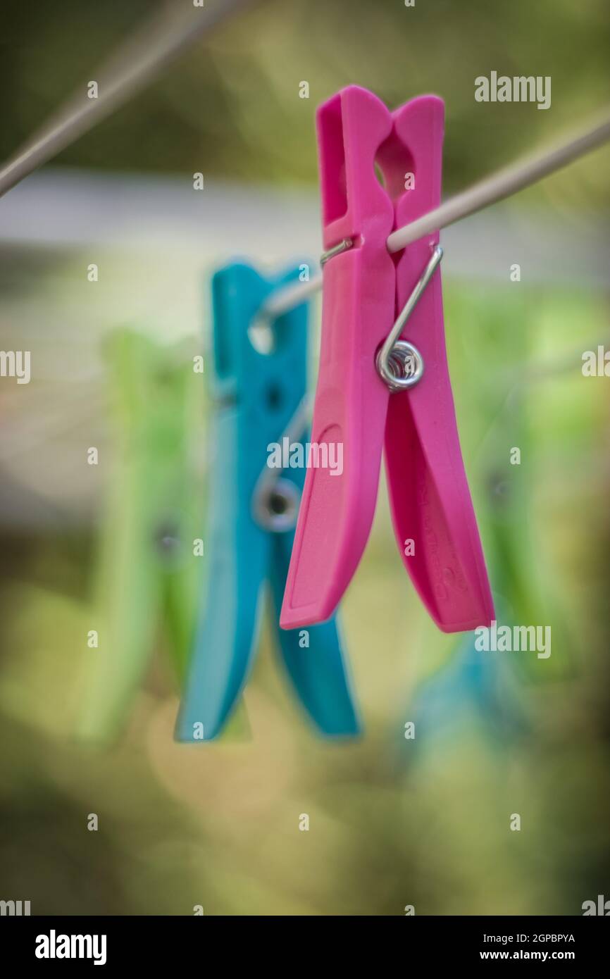 Clothespin clamp on rope, colourful, outdoors Stock Photo - Alamy