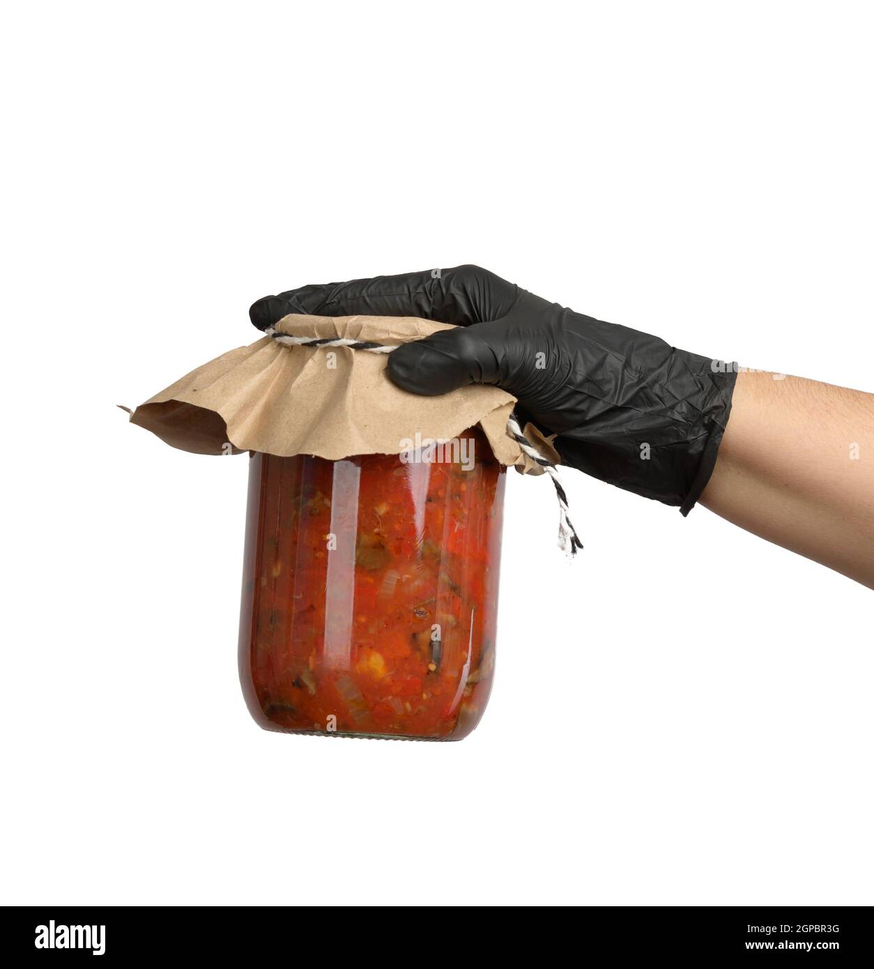 female hand in a black latex glove holds a glass jar with canned ...