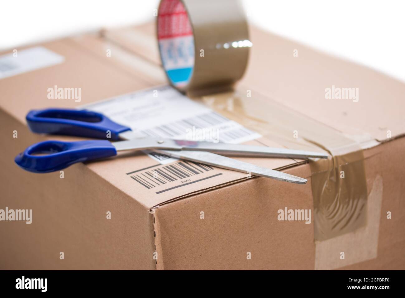 Shipping concept: Cardboard box, scissors and sticky tape Stock Photo ...