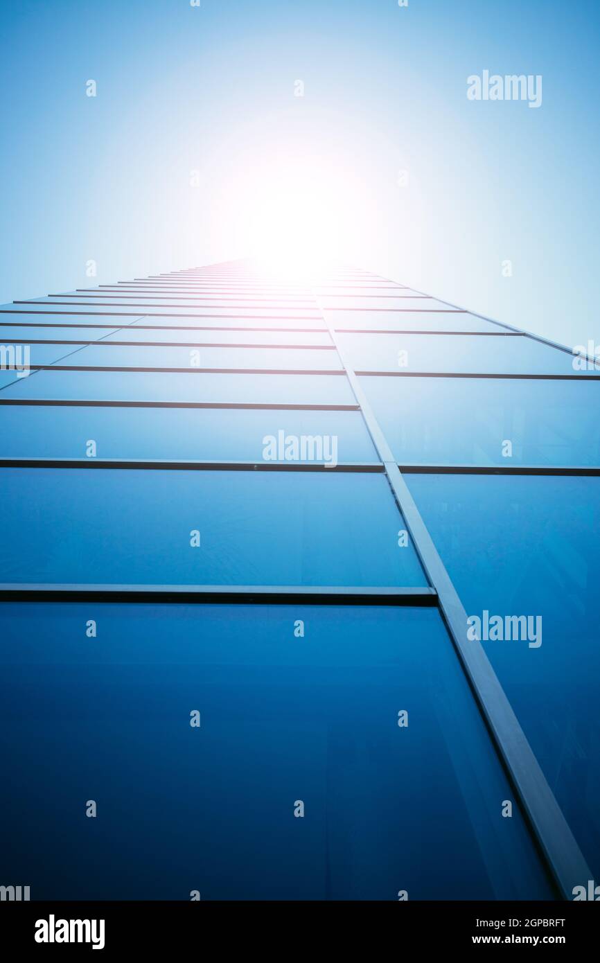 Modern skyscraper out of glass, blue sky and sunbeam Stock Photo - Alamy