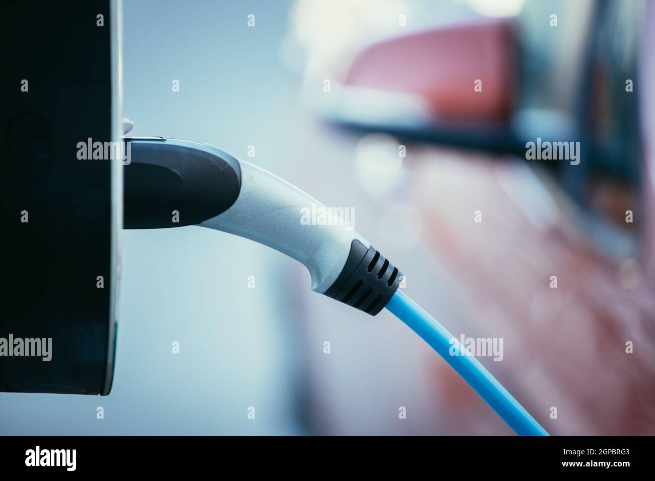 Electric car recharging with charge cable and plug leading to charge ...