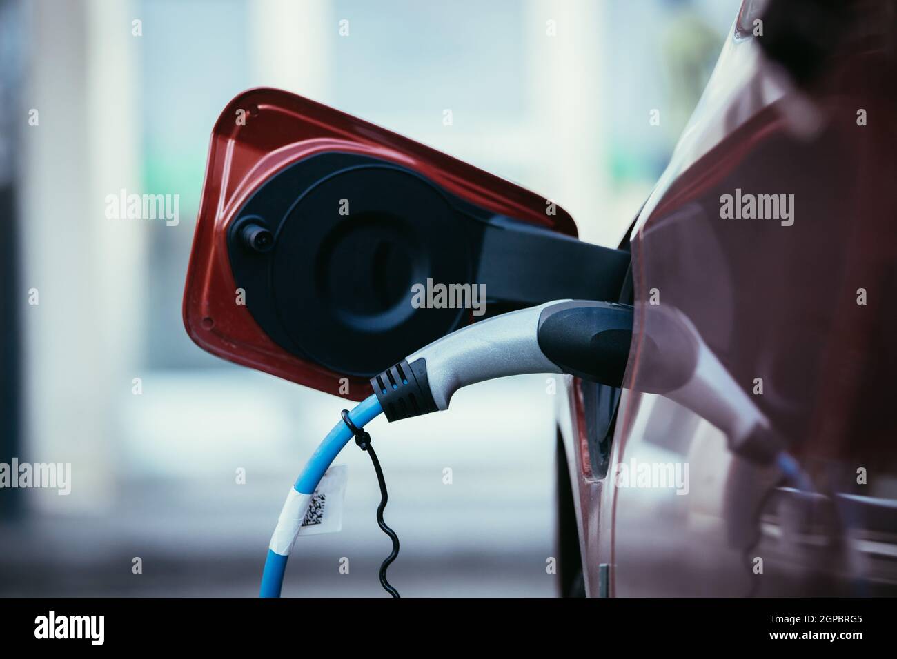 Electric car recharging with charge cable and plug leading to charge ...