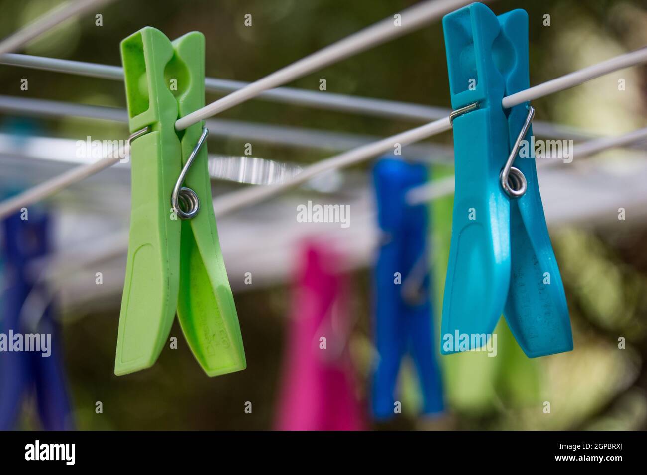 Clothespin clamp on rope, colourful, outdoors Stock Photo - Alamy