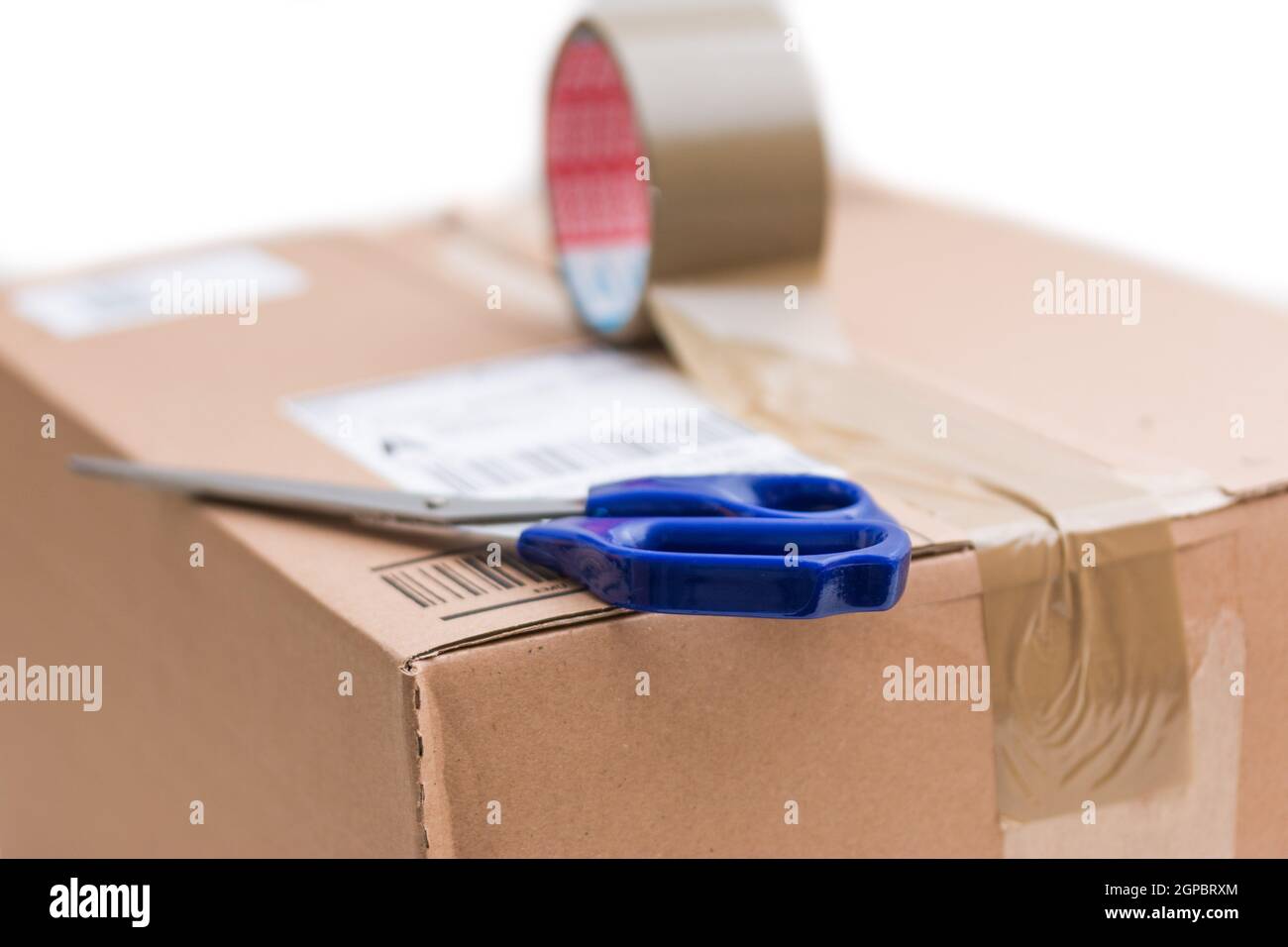 Shipping concept: Cardboard box, scissors and sticky tape Stock Photo ...