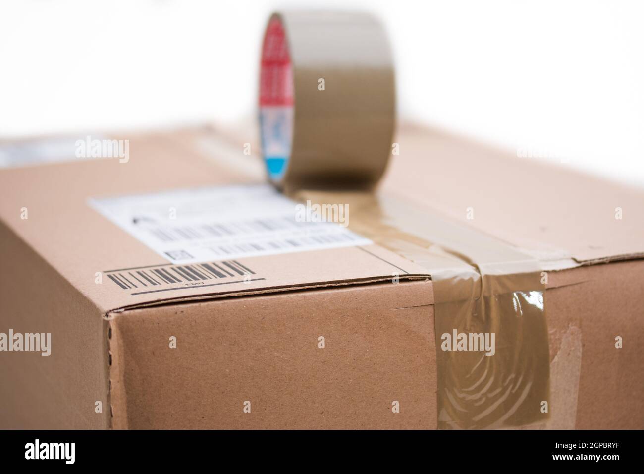 Shipping concept: Cardboard box and sticky tape Stock Photo - Alamy